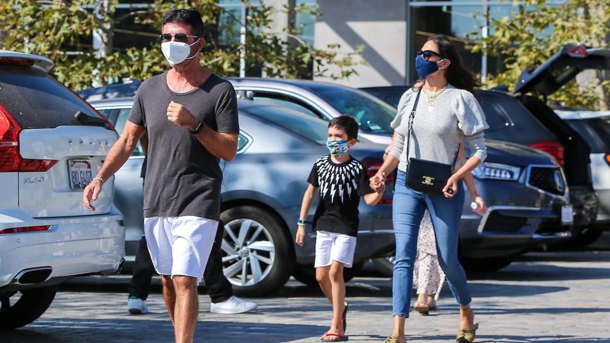Simon Cowell looks happy walking after breaking his back