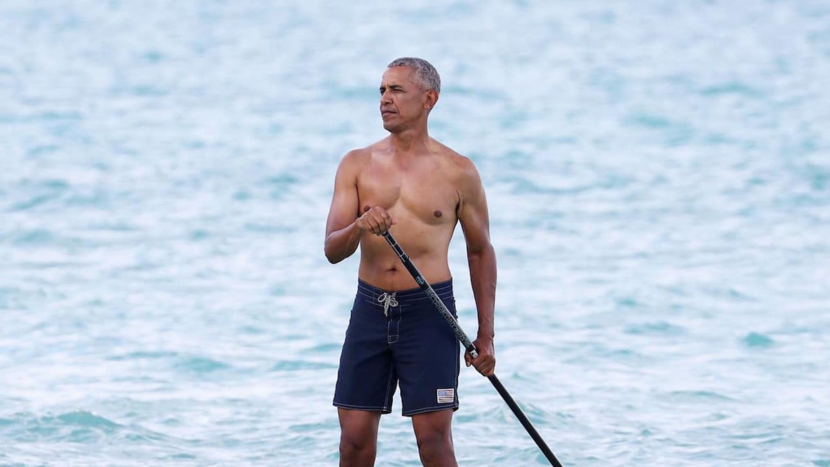 Barack Obama paddle-boards shirtless in his home state Hawaii