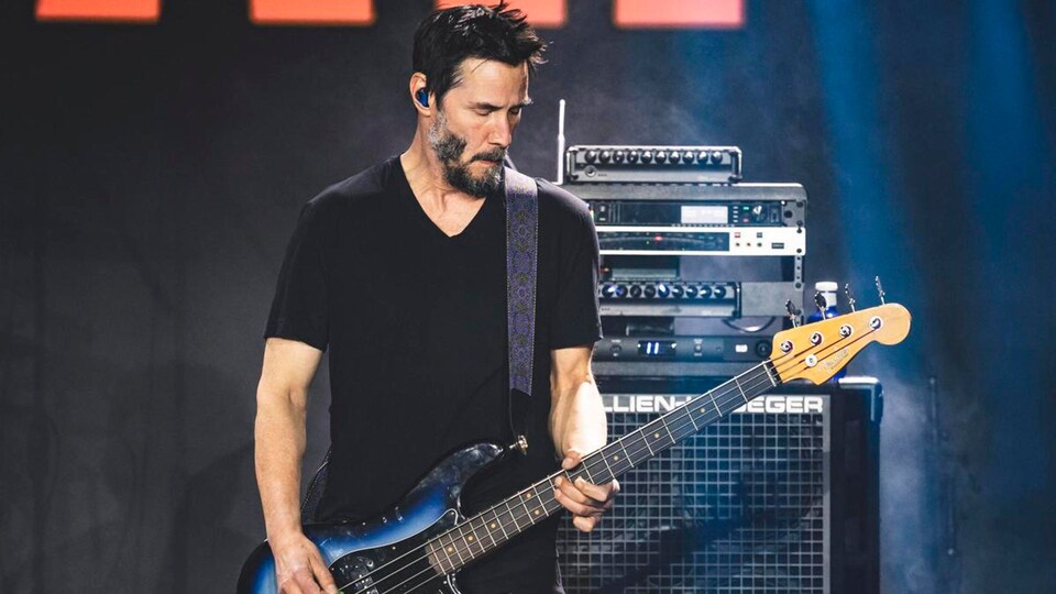Keanu Reeves shows off skills on the bass at Madrid concert
