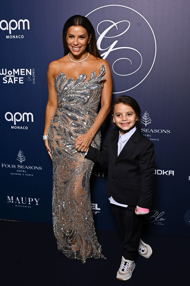 Eva Longoria holds hands with her 6-year-old son Santiago while ...