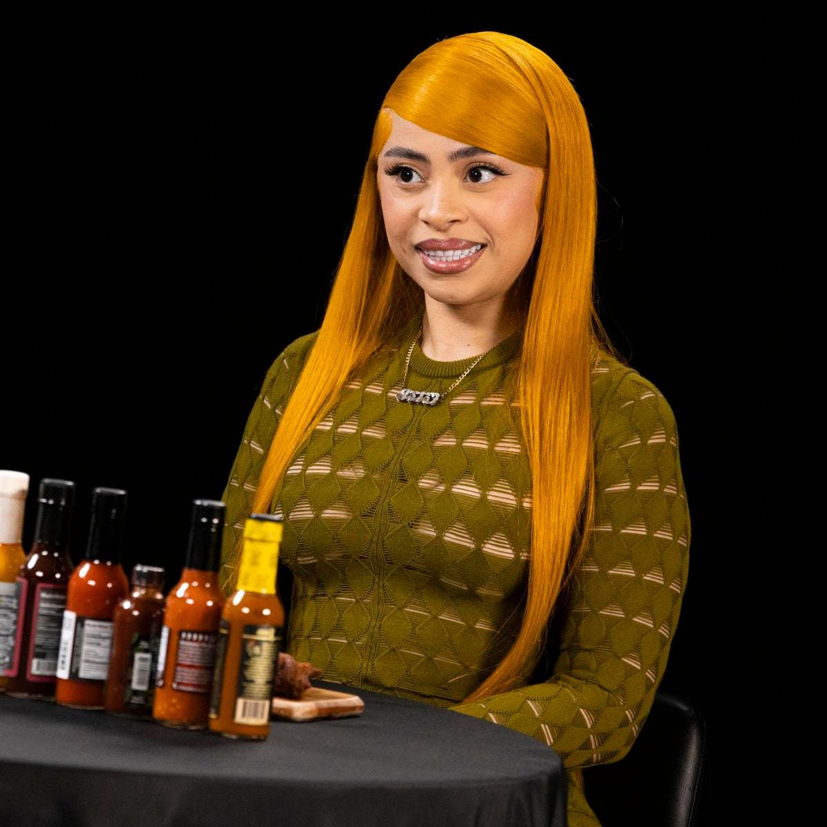 Ice Spice tackles fiery wings while talking about music