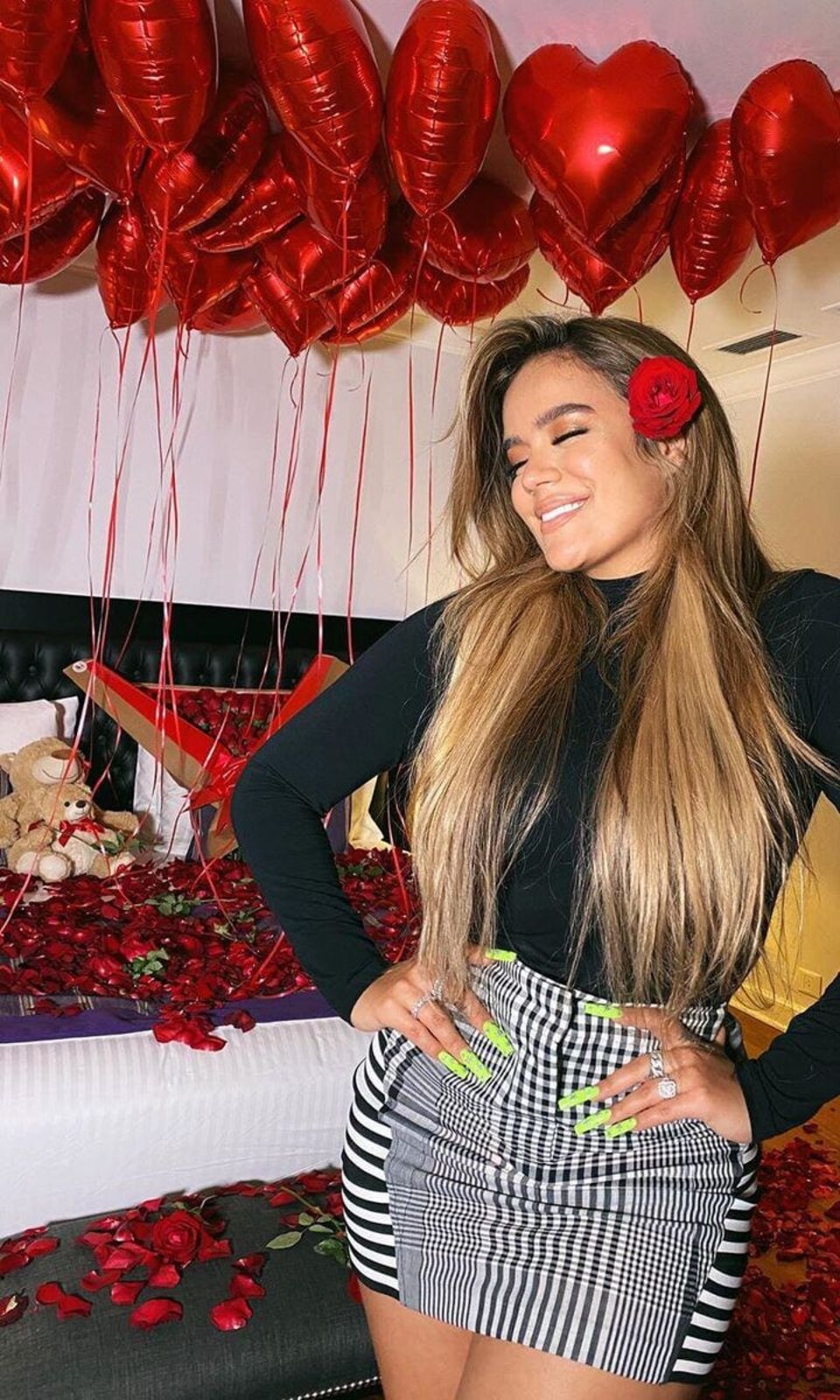 Anuel AA showers fiancé Karol G with hundreds of red roses