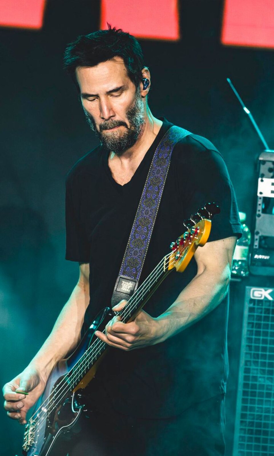 Keanu Reeves shows off skills on the bass at Madrid concert