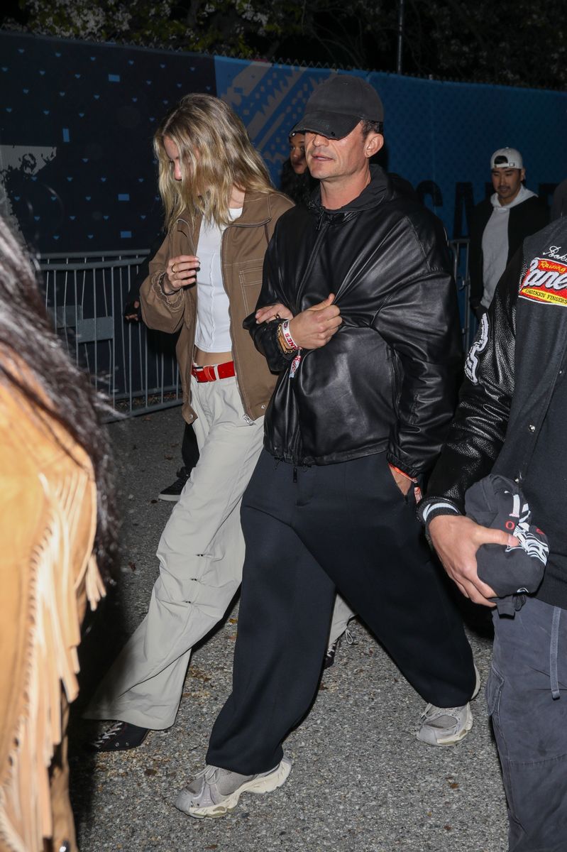 Orlando Bloom exits the Super Bowl arm-in-arm with a younger blonde model