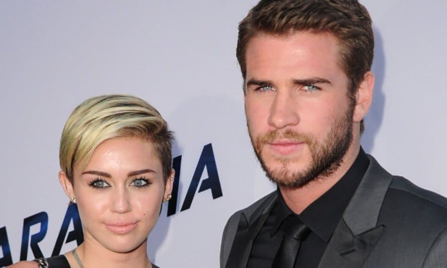 Miley Cyrus shows off engagement ring from Liam Hemsworth courtside at ...