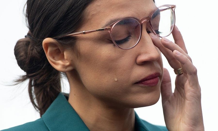 Alexandria Ocasio Cortez cries during immigration event